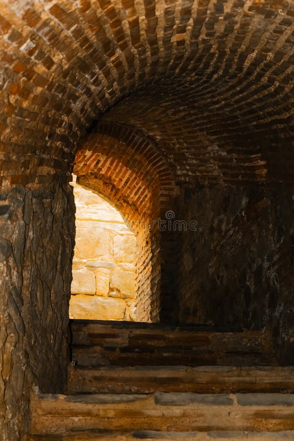 Ancient Stone Staircase and Brick Arch Passage Leading Towards Light ...