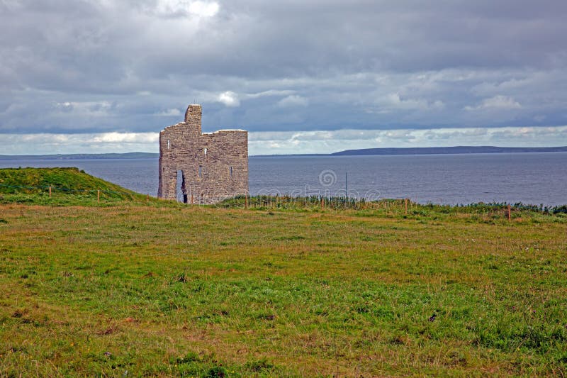 Ancient Stone Tower Ruins Under a Bright Blue Sky in Ireland Stock ...