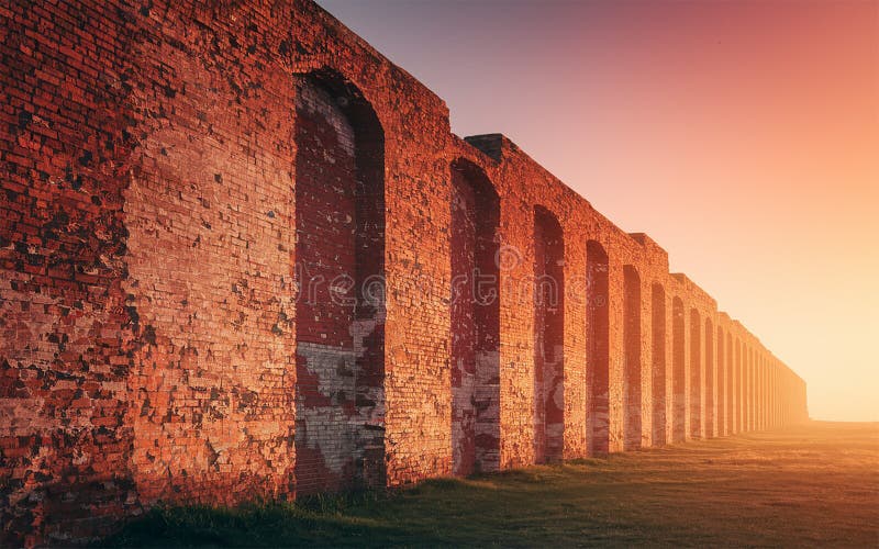 An Ancient, Weathered Red Brick Wall Stretches Endlessly into the ...
