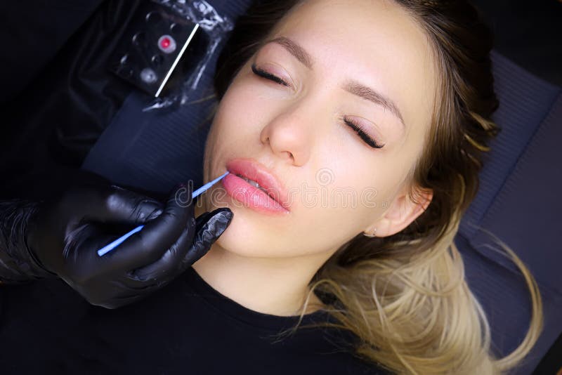 Anesthesia To the Model`s Lips with a Small Blue Brush before the ...