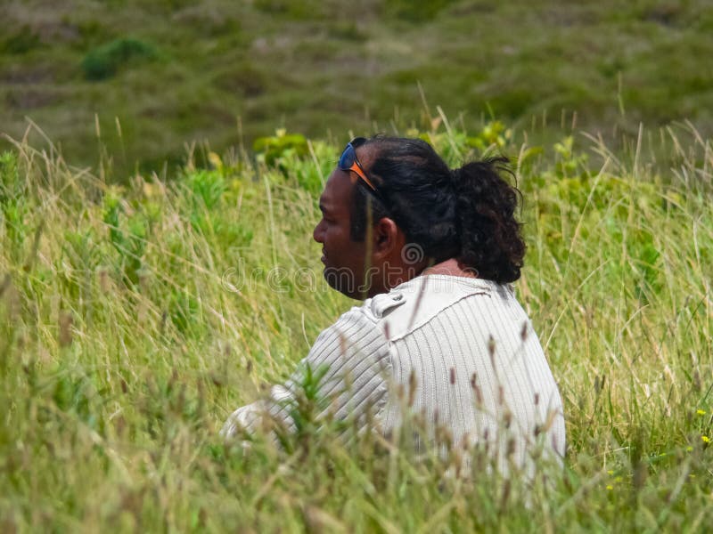 An Indigenous Resident of Easter Island Sits in the Grass Editorial ...
