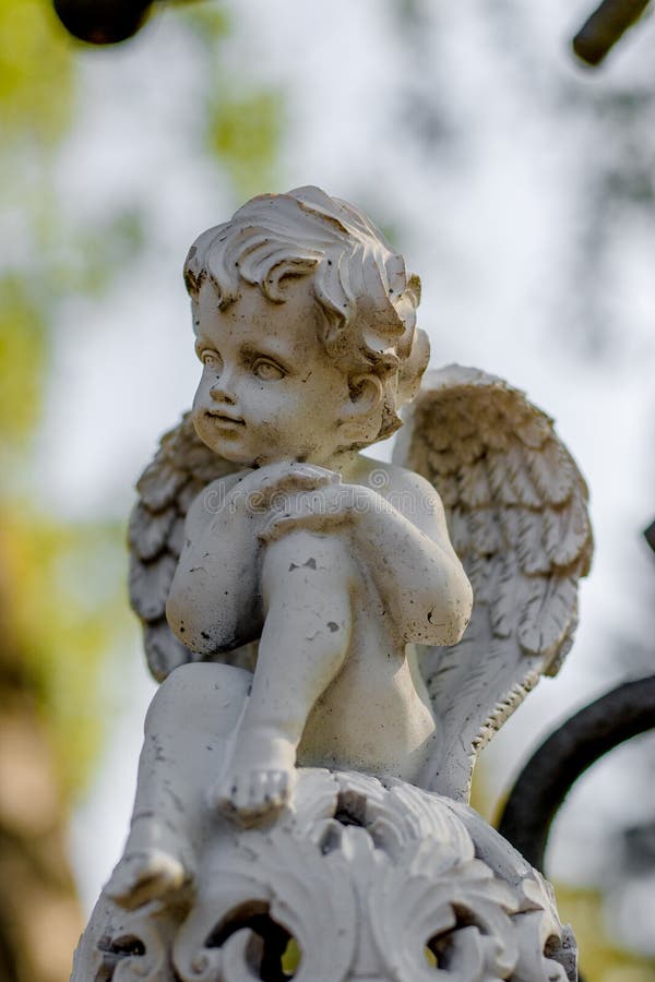 Angel sitting in the sun stock image. Image of ponder - 64039405