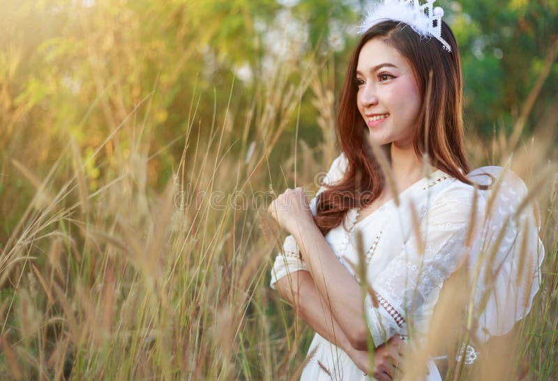 Angel Woman in a Grass Field with Sunlight Stock Photo - Image of light ...