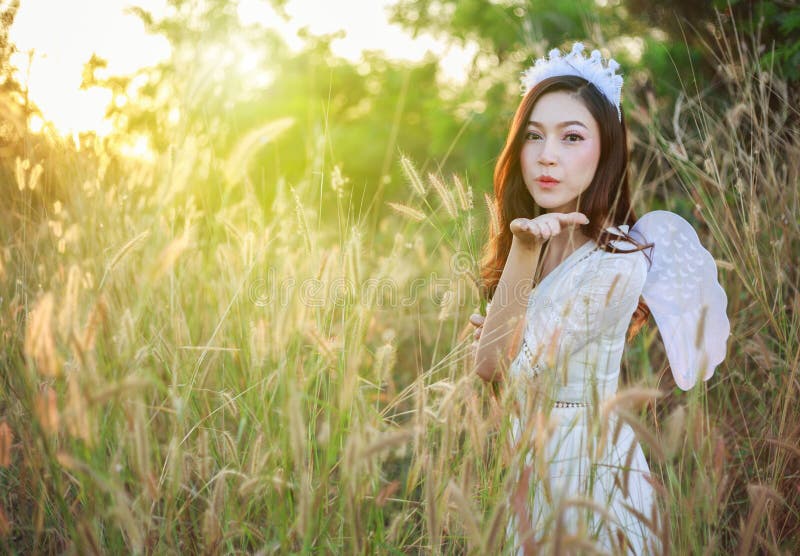 Angel Woman in a Grass Field with Sunlight Stock Image - Image of ...