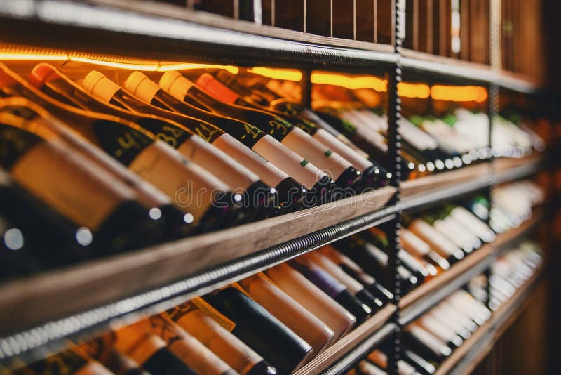 Angled Closeup of Wine Bottles in Rack Stock Image - Image of lined ...