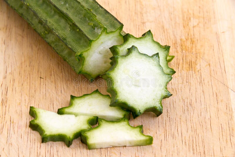 Angled Gourd or Fresh Loofah Slice on the Wooden Plate Stock Image ...