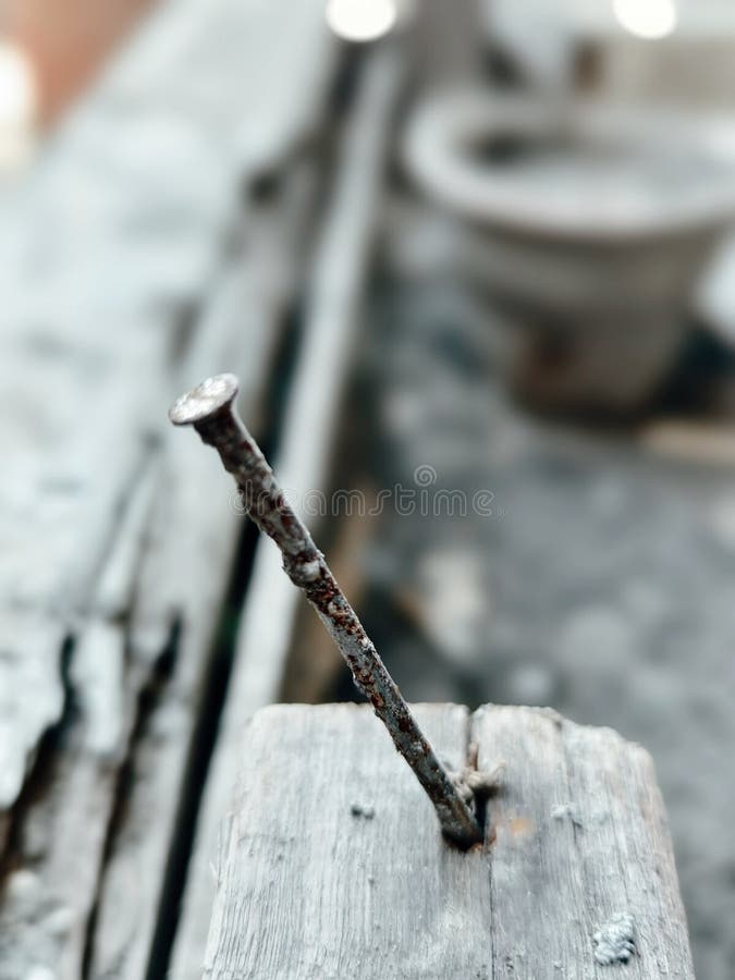Angled Nail Embedded in Wood Stock Photo - Image of time, cracked ...