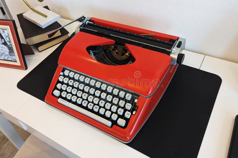 Angled Overhead View of White Desk Workplace with Bright Red Vintage ...