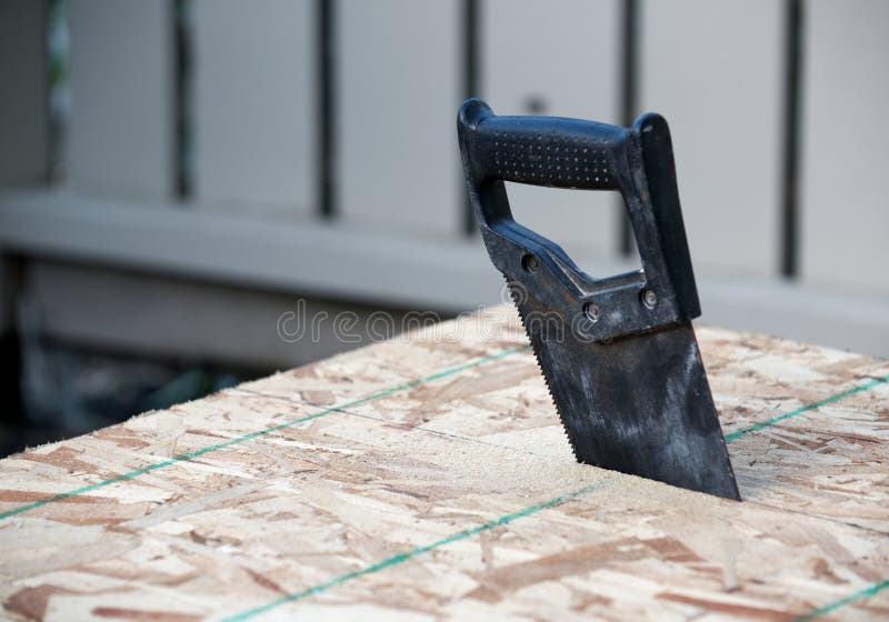 Angled View of a Hand Saw in Wood Stock Photo - Image of particle ...