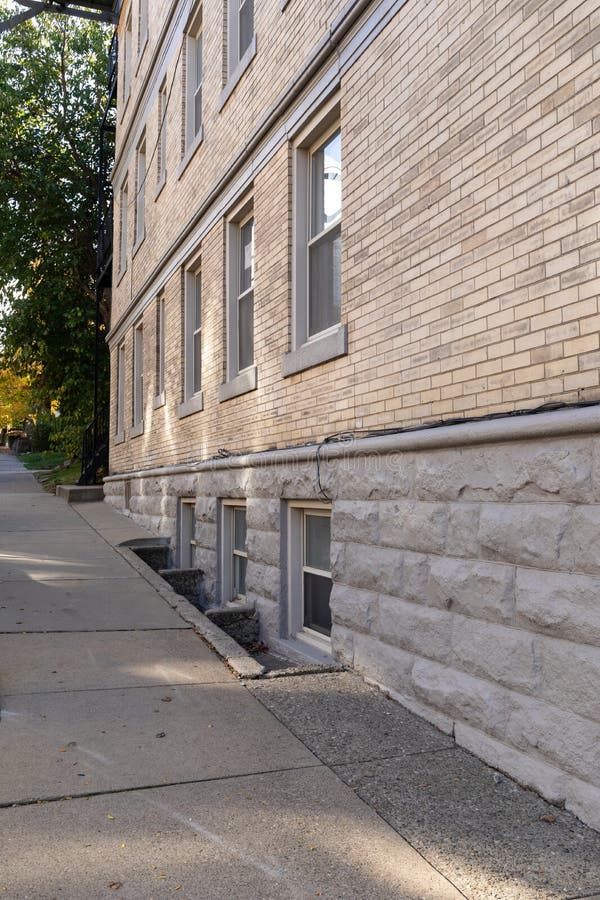 Angled View of Inclined Sidewalk and Building of Tan Brick and ...