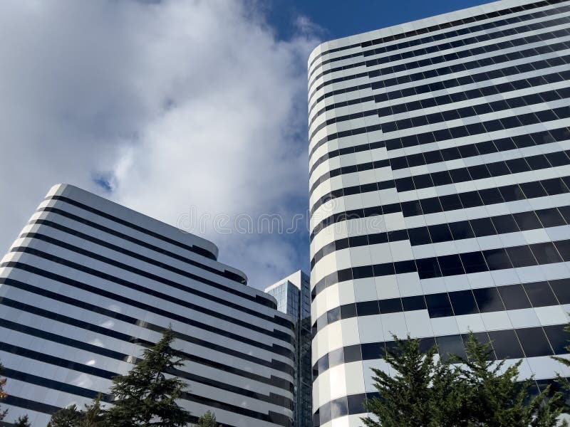 Angled View of a Large, Window Covered Building Corner Against a Blue ...