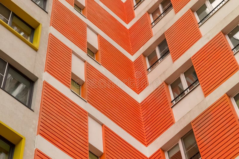 Angled View of a Modern Building Facade with Orange Cladding and ...