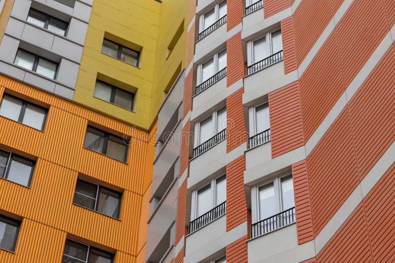 Angled View of a Modern Building Facade with Orange Cladding and ...