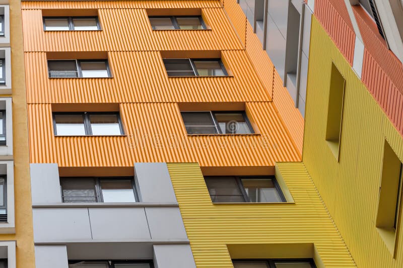 Angled View of a Modern Building Facade with Orange Cladding and ...