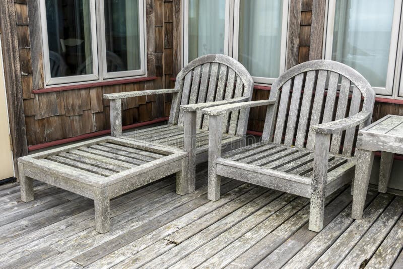Angled View of Wooden Deck Chairs at a Cliffside Cabin by the Sea in ...