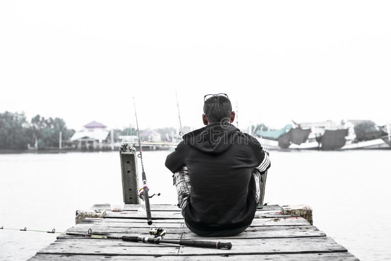 Angler catching fish stock photo. Image of lone, pole - 154931300