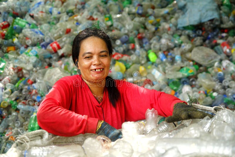 Workers of a Materials Recovery Facility Sort through Plastic Waste and ...