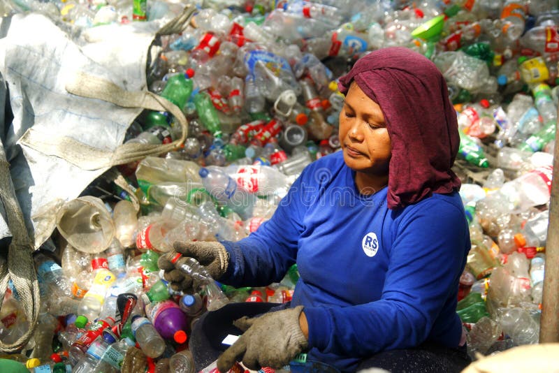 Workers of a Materials Recovery Facility Sort through Plastic Waste and ...