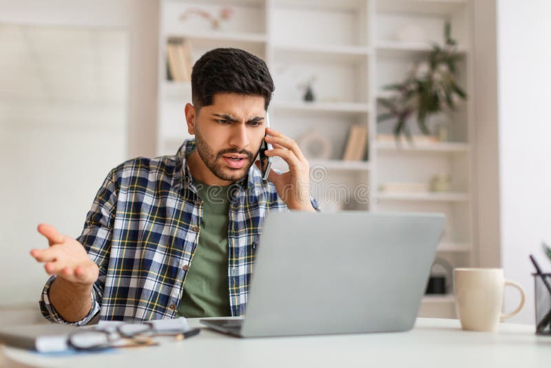 Angry Arab Man Talking on Cell Phone Using Laptop Stock Image - Image ...