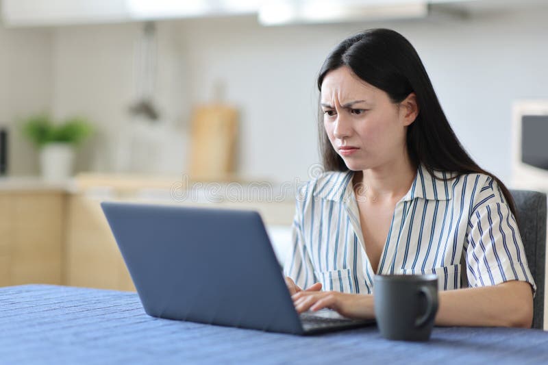 Angry Asian Woman Checking Laptop in a Kitchen Stock Photo - Image of ...