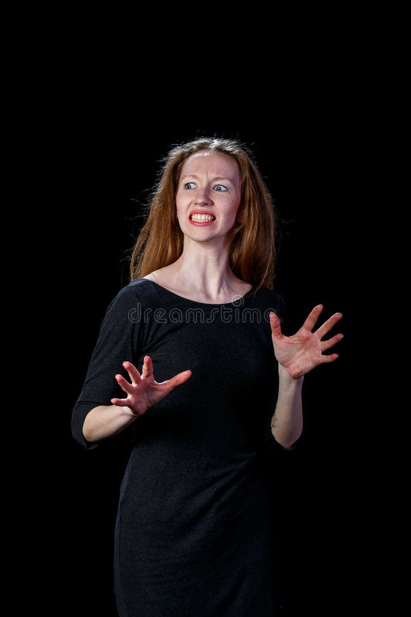 An Angry Beautiful Young Woman on a Black Background Stock Image ...