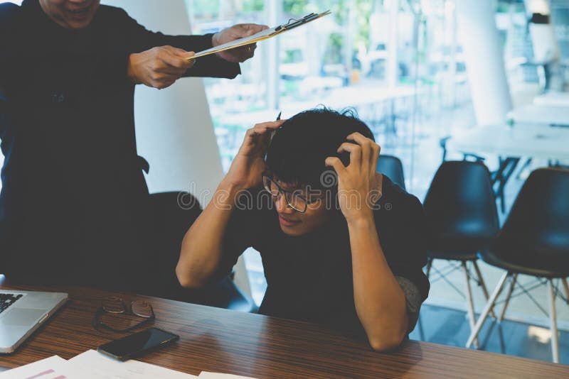 Angry Boss Hitting Employee with Document in Office Stock Photo - Image ...