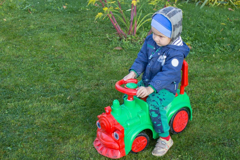 Angry Boy in a Toy Car,autumn Sad Boy Sitting on a Toy Car in the Yard ...