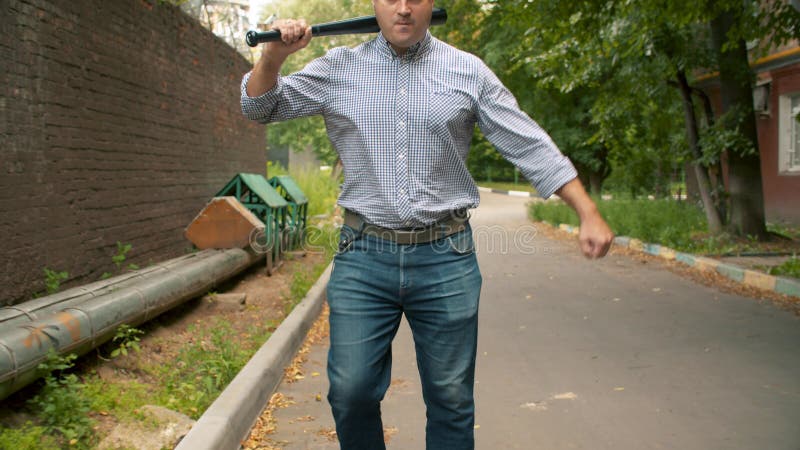 An Angry Bully with a Bat in His Hands Stock Footage - Video of cruel ...