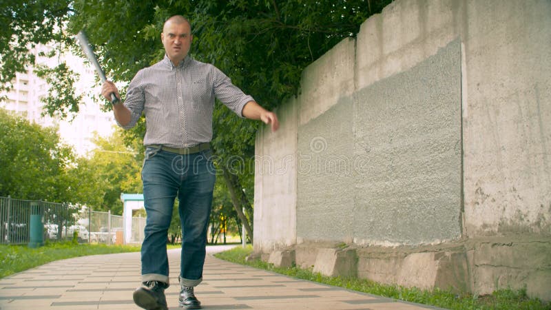 An Angry Bully with a Bat in His Hands Stock Footage - Video of cruel ...
