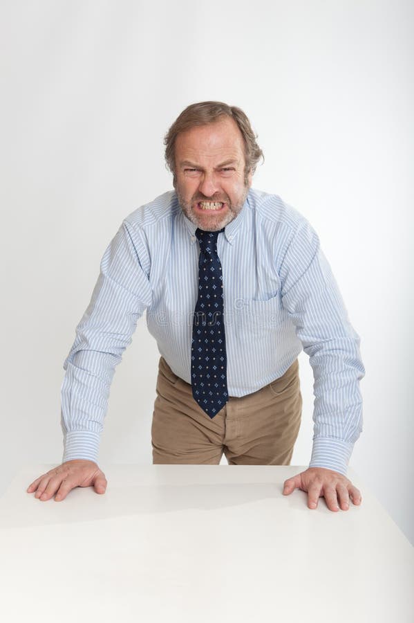 Angry Businessman Leaning on a Table Stock Photo - Image of standing ...