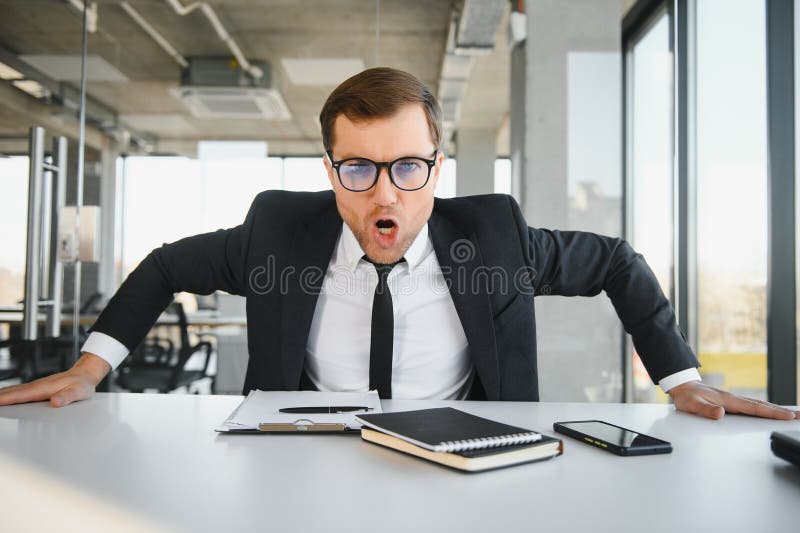 Angry Businessman Sitting at the Table and Screaming. Stock Image ...