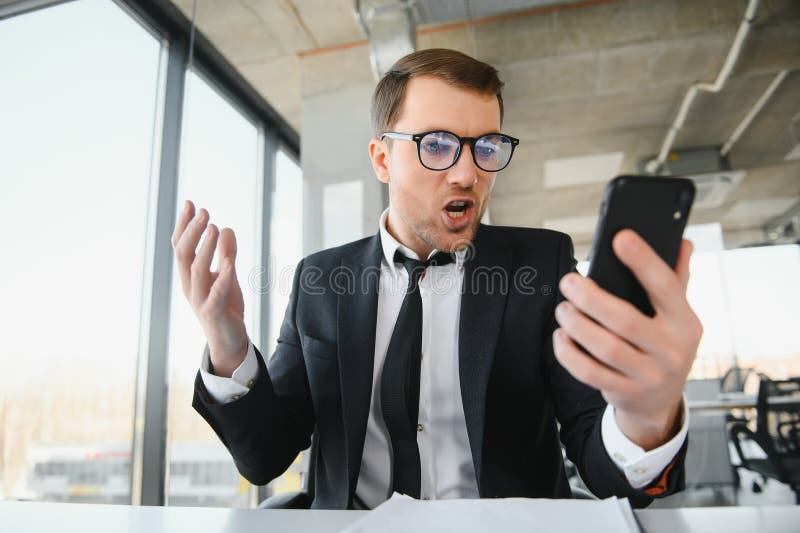 Angry Businessman Sitting at the Table and Screaming. Stock Photo ...