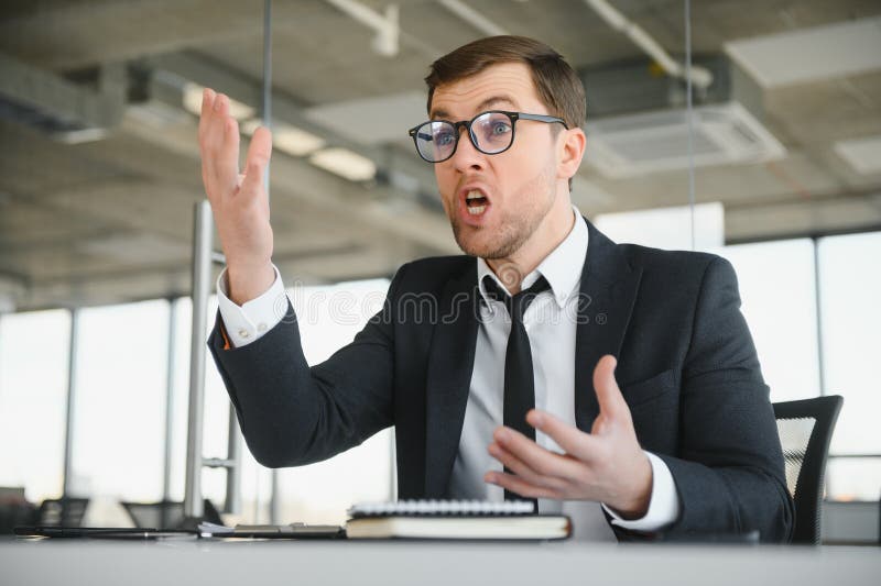 Angry Businessman Sitting at the Table and Screaming. Stock Photo ...