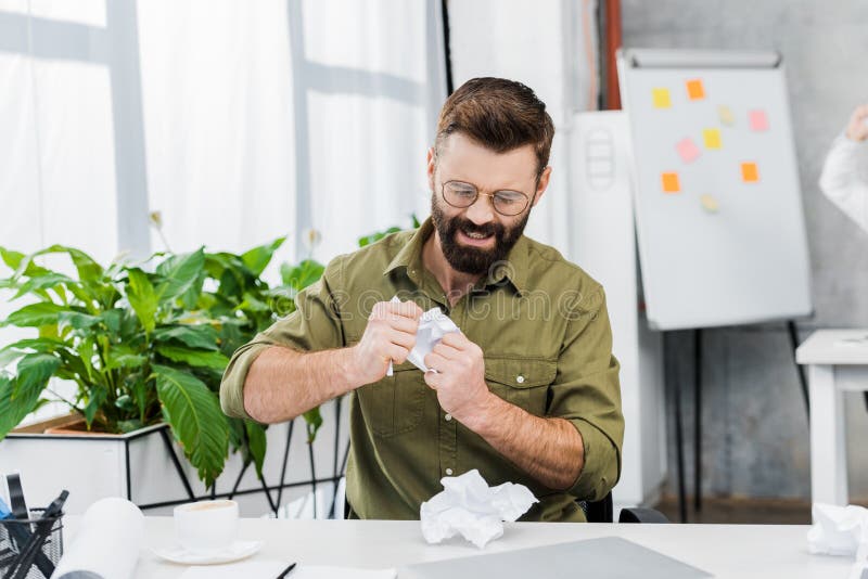 Angry Businessman Tearing Paper at Table Stock Photo - Image of casual ...
