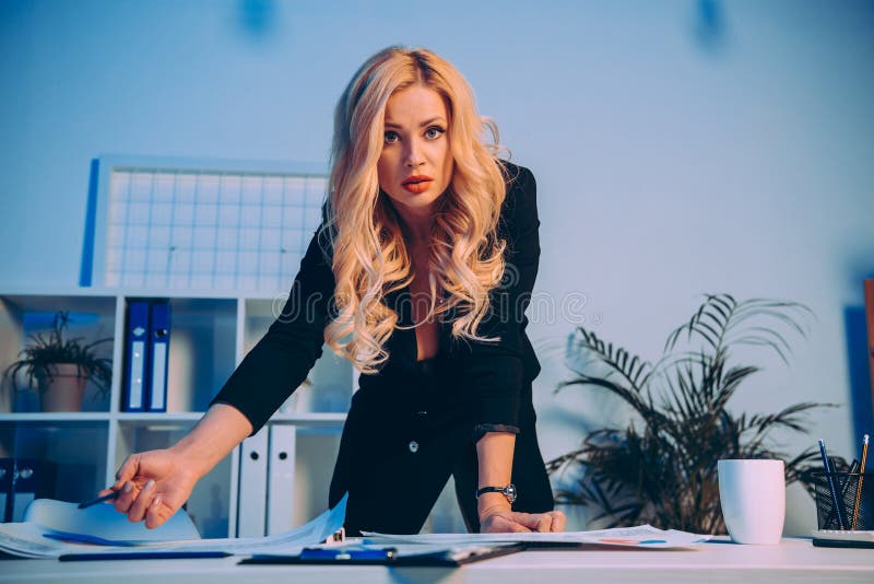 Woman Sitting on Table and Pointing Stock Photo - Image of gesture ...