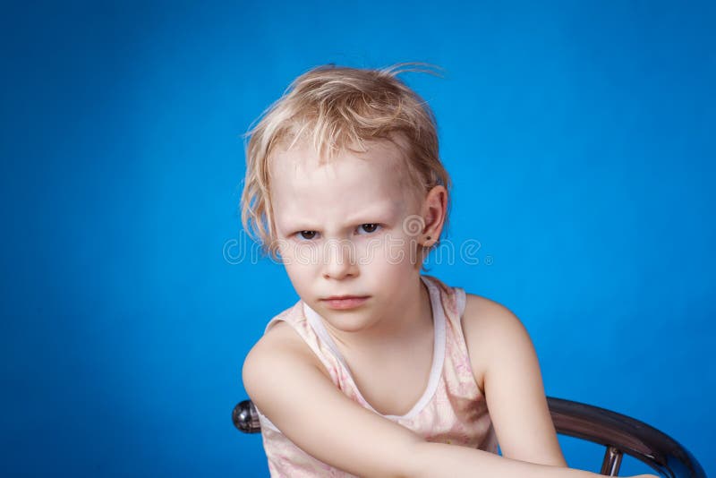 Angry Child on a Blue Background Stock Photo - Image of front, girls ...