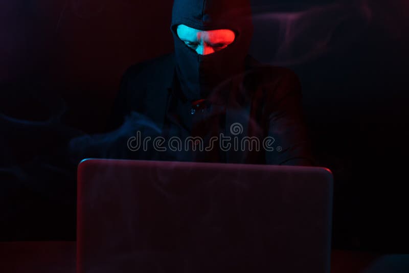 Angry Computer Hacker in Suit Stealing Data from Laptop Illuminated by ...