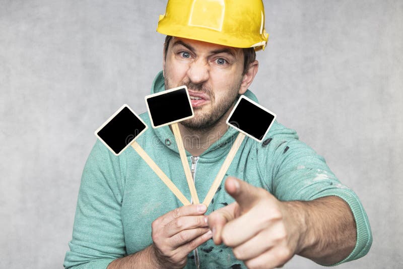 Angry Construction Worker Holding a Blackboard with Space for Text or ...