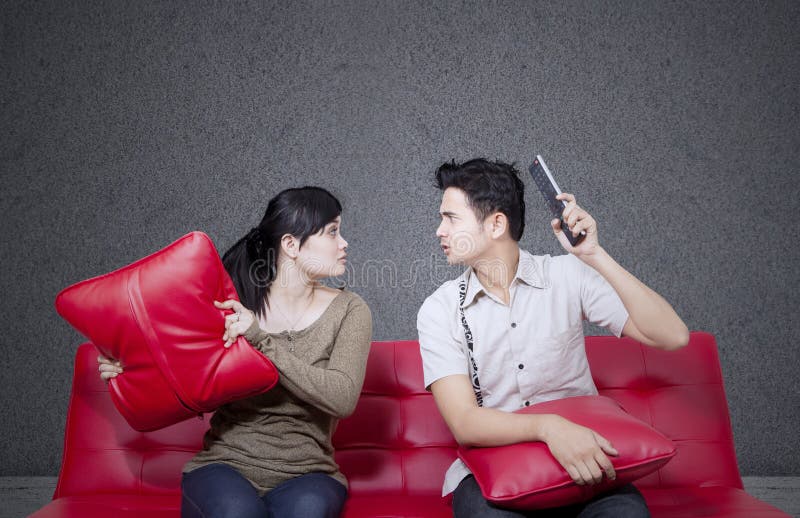 Angry Couple Fight on Red Sofa Stock Photo - Image of background, female: 30459108