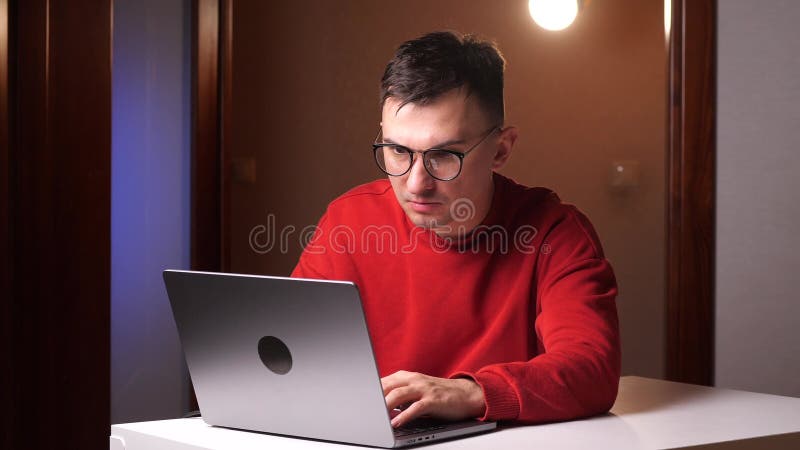 Angry Dissatisfied Man with Glasses Typing a Message on a Laptop Stock ...