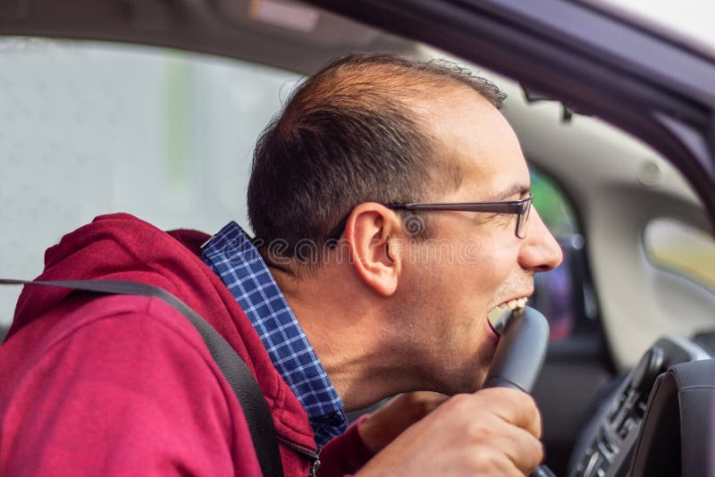 Angry Driver Bites the Steering Wheel in Traffic Jam Stock Photo ...