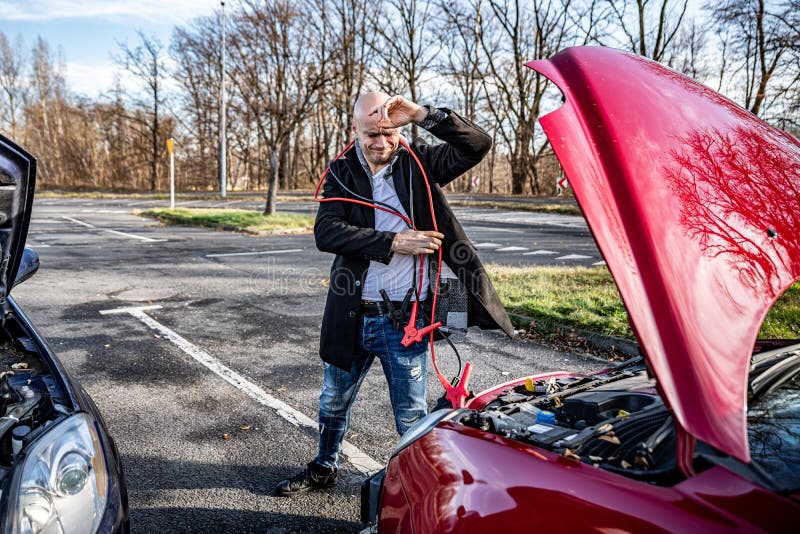 Angry Driver Trying To Start Broken Car with Jumper Cables Stock Photo ...