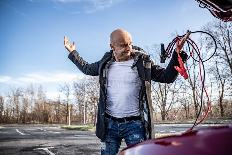 Angry Driver Trying To Start Broken Car with Jumper Cables Stock Image ...