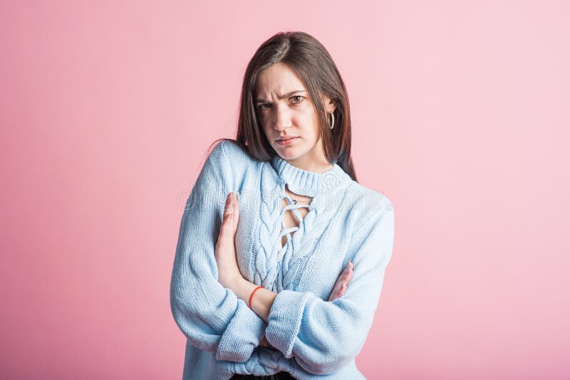 Angry Emotions of a Brunette Girl in the Studio on a Pink Background ...