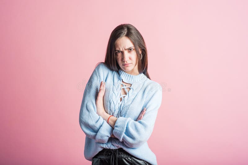 Angry Emotions of a Brunette Girl in the Studio on a Pink Background ...