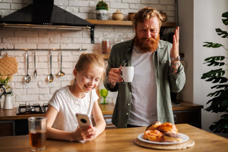 Angry Father Holding Coffee while Daughter Using Smartphone during ...