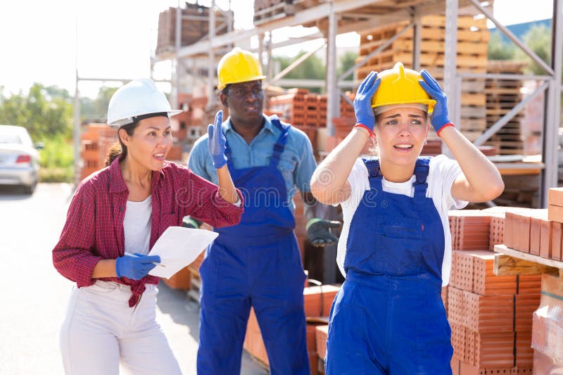 Angry Female Boss Scolds Her Young Girl Subordinate At A Warehouse