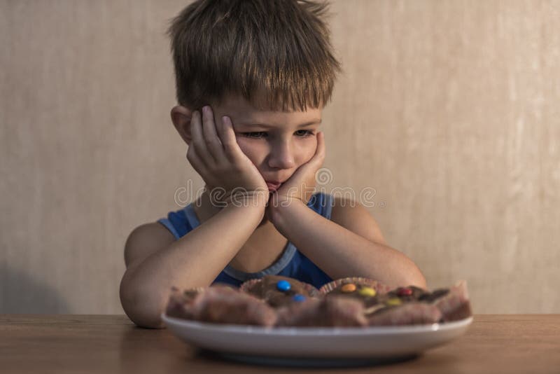 Angry Little Boy Sitting at the Dinner Table. Stock Photo - Image of ...