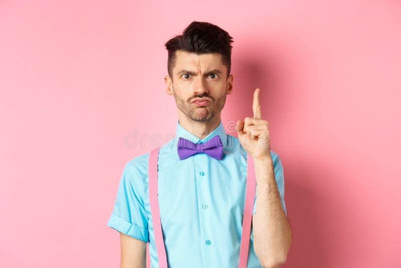 Frowning Grumpy Teen Boy Standing with Folded Arms Over Blue Background ... Frowning Grumpy Teen Boy Standing with Folded Arms Over Blue Background ...