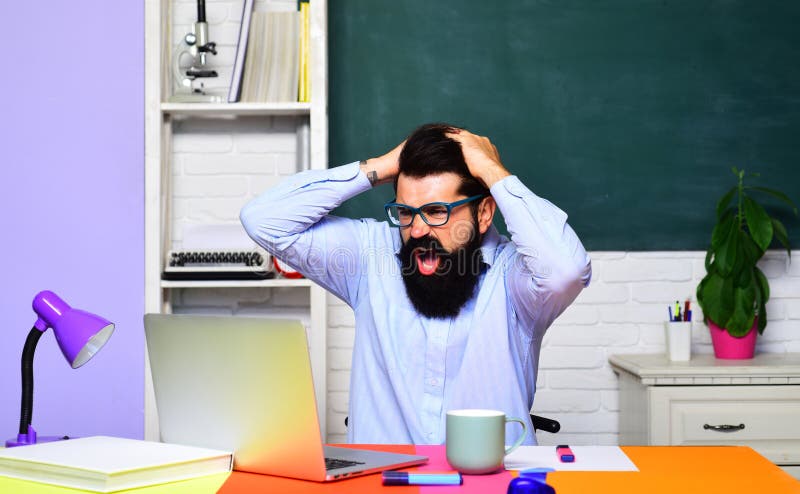 Angry Male University Student Working with Laptop Computer in Classroom ...